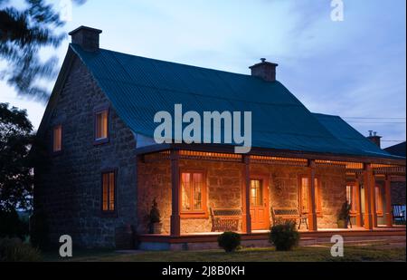 Old circa 1850 style cut stone home at dusk Stock Photo - Alamy