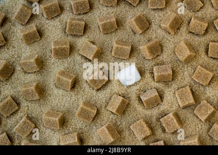 Natural,brown sugar cubes designed on granulated brown sugar,background ...