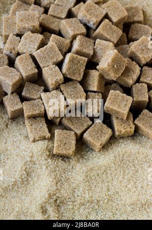 Natural,brown sugar cubes designed on granulated brown sugar,background ...
