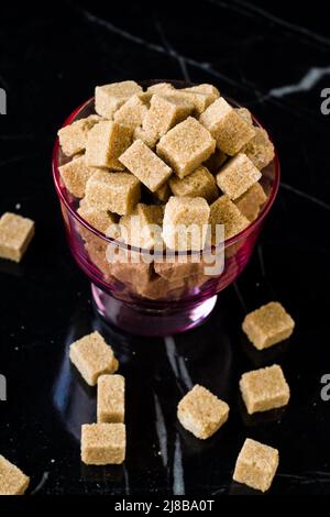 Natural,brown sugar cubes designed on granulated brown sugar,background ...