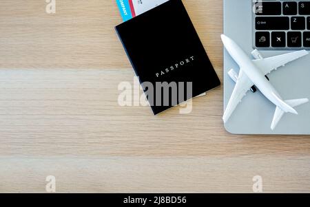 Passport black cover with flight ticket near white airplane toy on ...