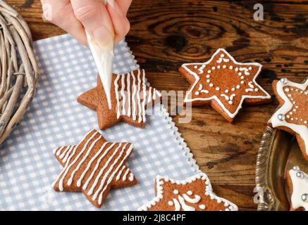 Decorating gingerbread cookies for christmas. Steps of making biscuits ...