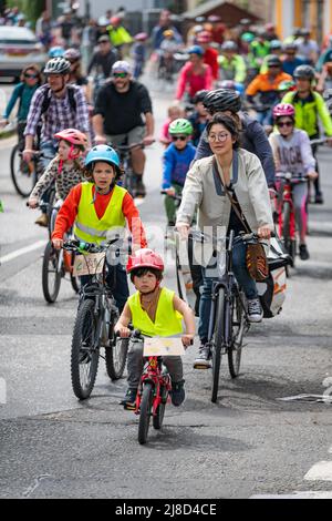 Participants of the Critical Mass bicycle ride lift their bicycles ...