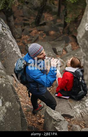 Trekker drinking water from bottle in a river Stock Photo - Alamy