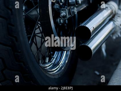 rear view of classical motorcycle pair of exhaust chrome pipes ...