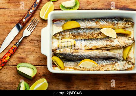 Tasty baked pelengas, fish with kiwi and lime Stock Photo - Alamy
