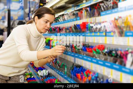 woman customer looking new pen in stationery store Stock Photo - Alamy