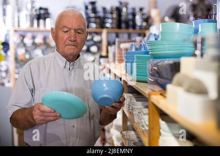 Elderly man choices energy saving lamp at hardware store Stock Photo ...