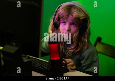 Little kid using desktop pc by night, child boy illuminated by the blue ...