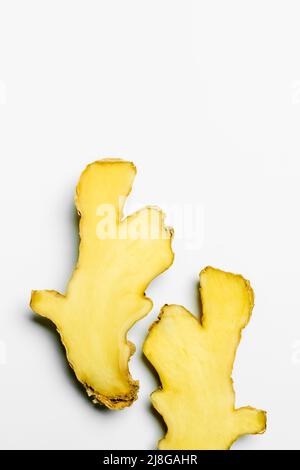 Fresh cut ginger on white background Stock Photo - Alamy