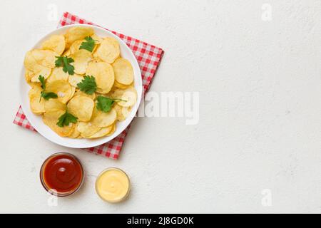Top view chips with sause in bowl on colored background, top view with ...