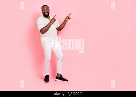 Portrait of positive nice person indicate finger arm hold empty space ...