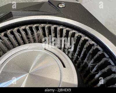 Dust is caked onto the cooling fan of an NVIDIA computer graphics card ...