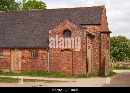 Deserted brick building with bricked up windows, boarded up window ...