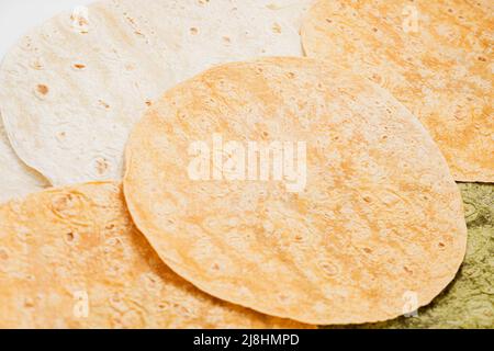 Tomato, spinach flavored and plain wheat tortilla wraps. Spanish or ...