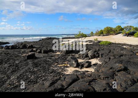 Solidified lava on the sandy O'oma Beach near Kailua-Kona in the west ...