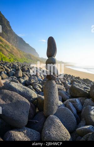 Stones stacked on the beach of the Polihale State Park at the western ...