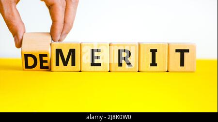 Demerit or merit symbol. Businessman turns wooden cubes and changes the ...
