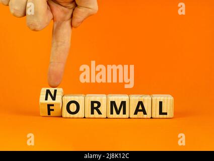 Formal or normal symbol. Businessman turns wooden cubes and changes the ...