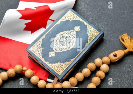 Canadian flag with Muslim prayer beads on blue wooden background Stock ...