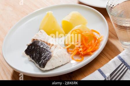 Steamed hake with grated carrot and potatoes Stock Photo - Alamy