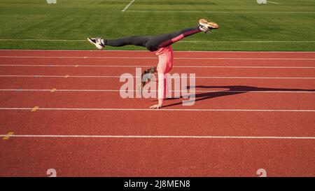 There is always a new trick to learn. Girl do handstand with legs in ...