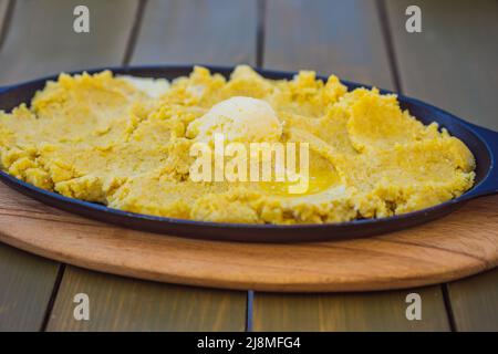 Traditional Montenegrin Meal. Kacamak in a black pan Stock Photo - Alamy