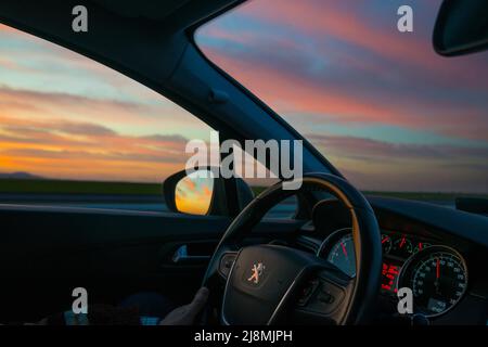 Sunset viewed from inside a car Stock Photo - Alamy