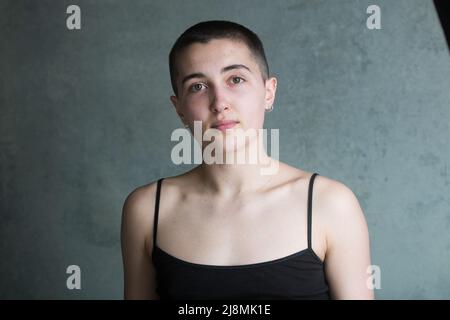 non-binary, they / them with shaved head and kind expression Stock ...