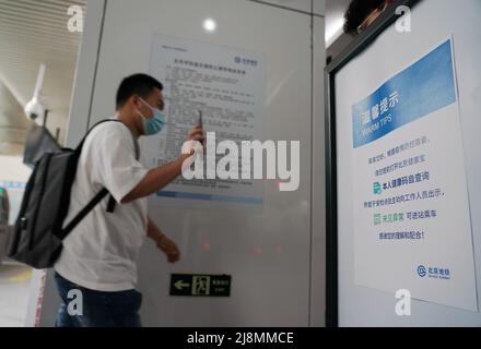 Beijing, China. 17th May, 2022. A passenger shows his health QR code ...
