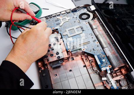 a computer repairman disassembles, repairs and does preventive ...