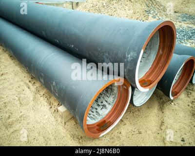 Water pipes for supplying communications lie on the construction site ...