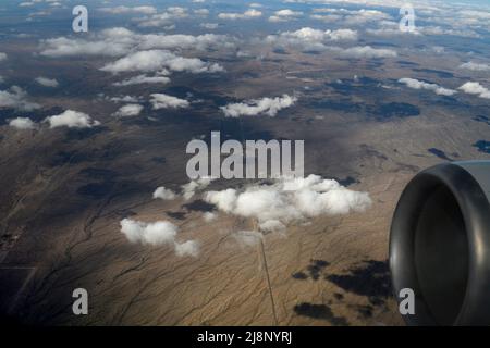 A view of clouds and irrigated fields as seen from a passenger aircraft ...