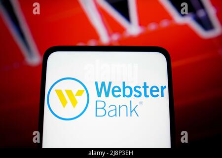 In this photo illustration the Webster Bank logo seen displayed on a ...
