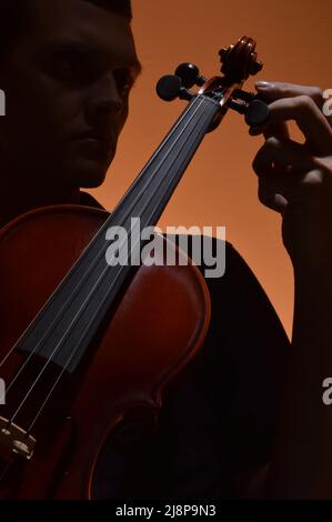 Violin being tuned by musician Stock Photo - Alamy
