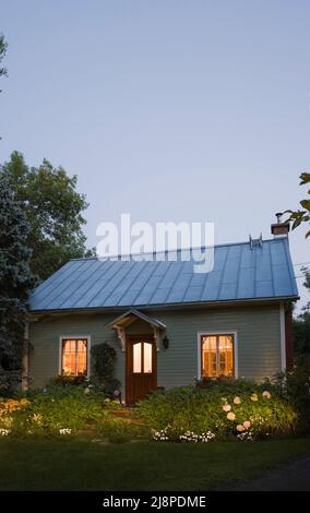 Old circa 1900 Canadiana cottage style home with olive green wood plank ...