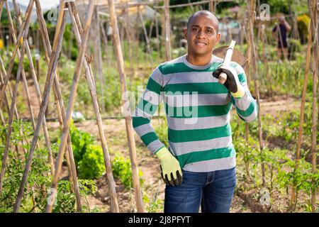 Pakistani man gardener working at land with garden mattock Stock Photo ...