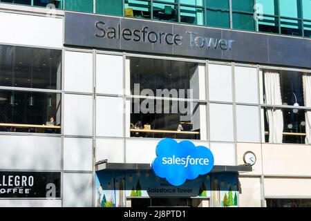 Close-up of blue Salesforce cloud logo on illuminated pillar with palm ...