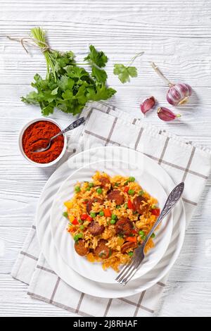 browned smoked sausages with rice, bell pepper, onion and green peas in ...