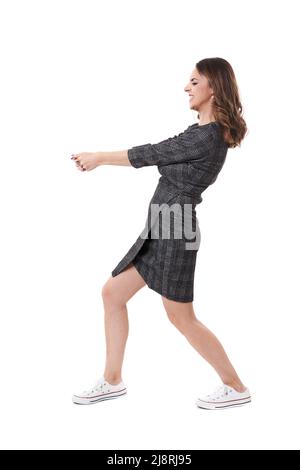 Young businesswoman pulling a heavy weight, useful in digital ...