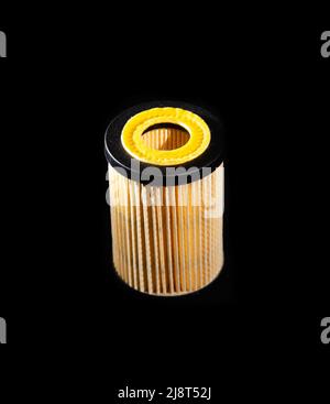 New orange oil filter on a black background. Automotive engine ...