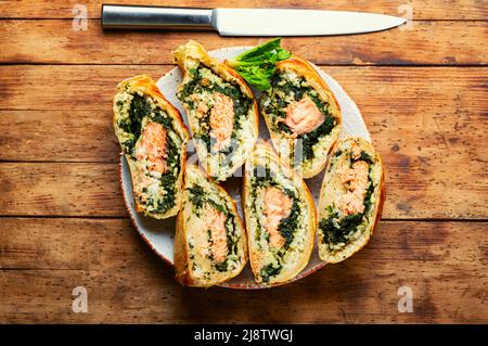 Appetizing fish pie made from salmon fish, rice and spinach. Red fish ...