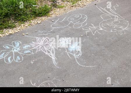 Children's drawings on the asphalt with chalk. Selective focus. nature ...