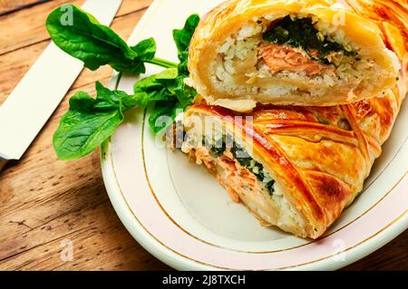 Appetizing fish pie made from salmon fish, rice and spinach. Red fish ...