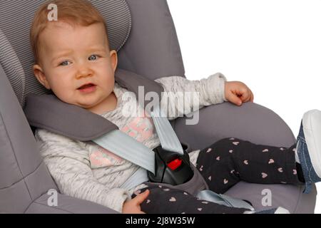 Toddler sits strapped in a child seat Stock Photo - Alamy