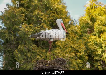 Plastic sculpture of a plastic stork in a nest Stock Photo - Alamy