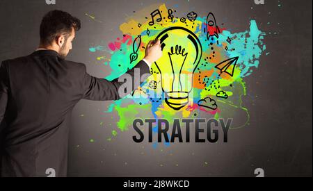 businessman drawing colorful light bulb Stock Photo - Alamy