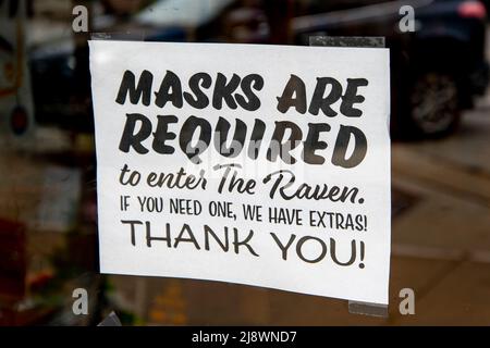 Lawrence, Kansas. Facemasks are required sign in store window and ...