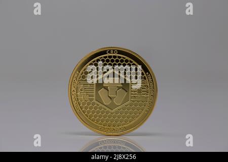 CRONOS CRO Cryptocurrency Physical Coin placed on reflective surface ...