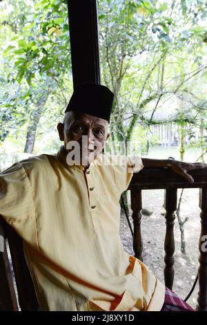 A Malay man wearing a traditional cap Stock Photo - Alamy